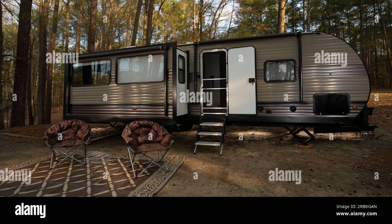 RV in a shady spot in a forest duting the day in North Carolina Stock ...