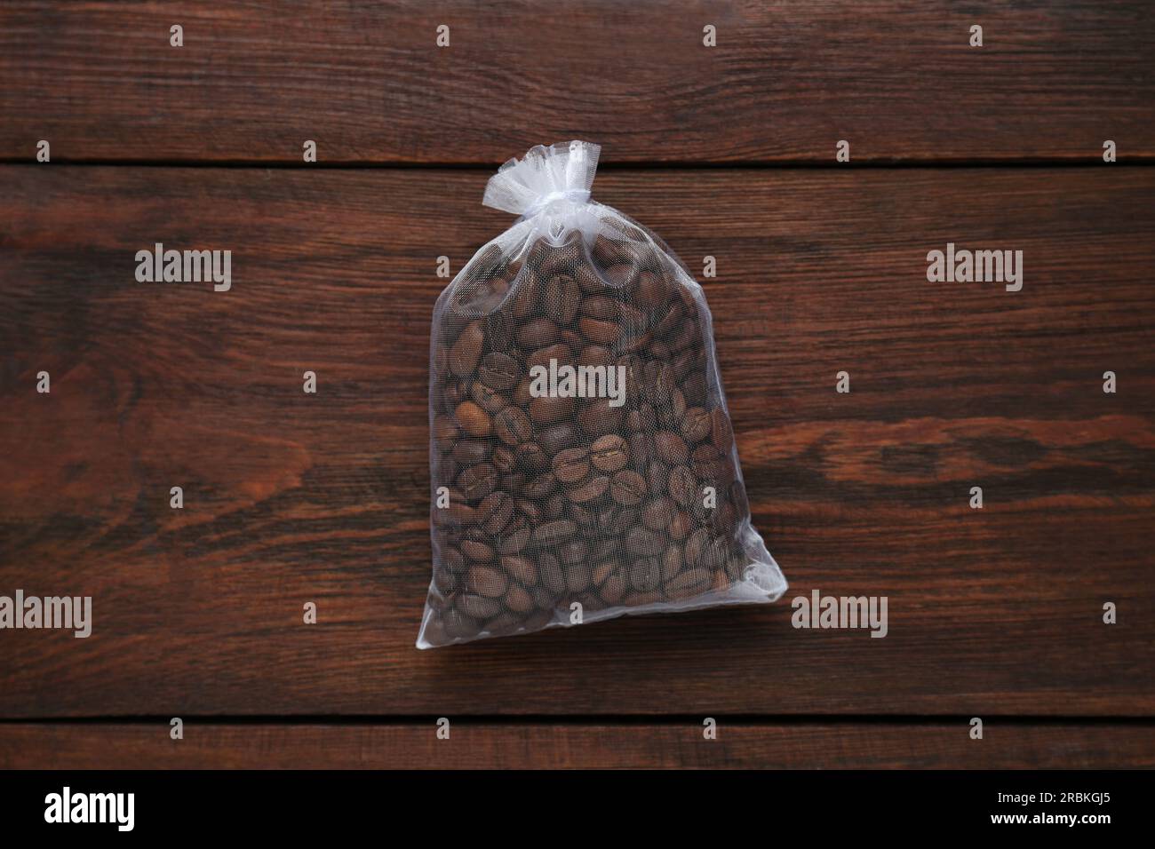 Scented sachet with coffee beans on wooden table, top view Stock Photo ...