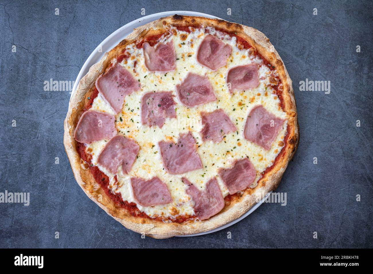 Homemade ham and cheese pizza on a rustic background. top view Stock ...