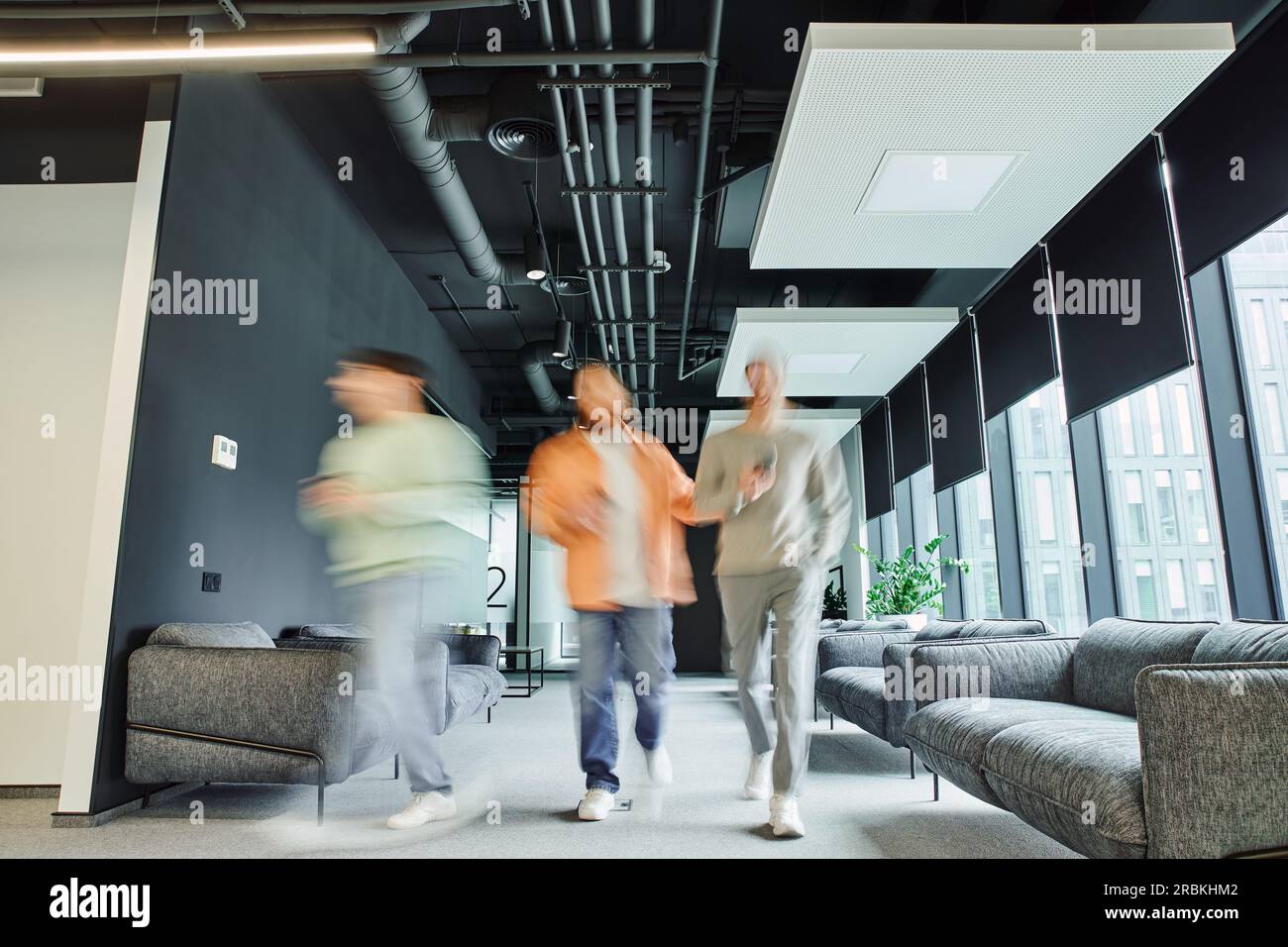 motion blur of modern entrepreneurs in casual clothes walking along ...