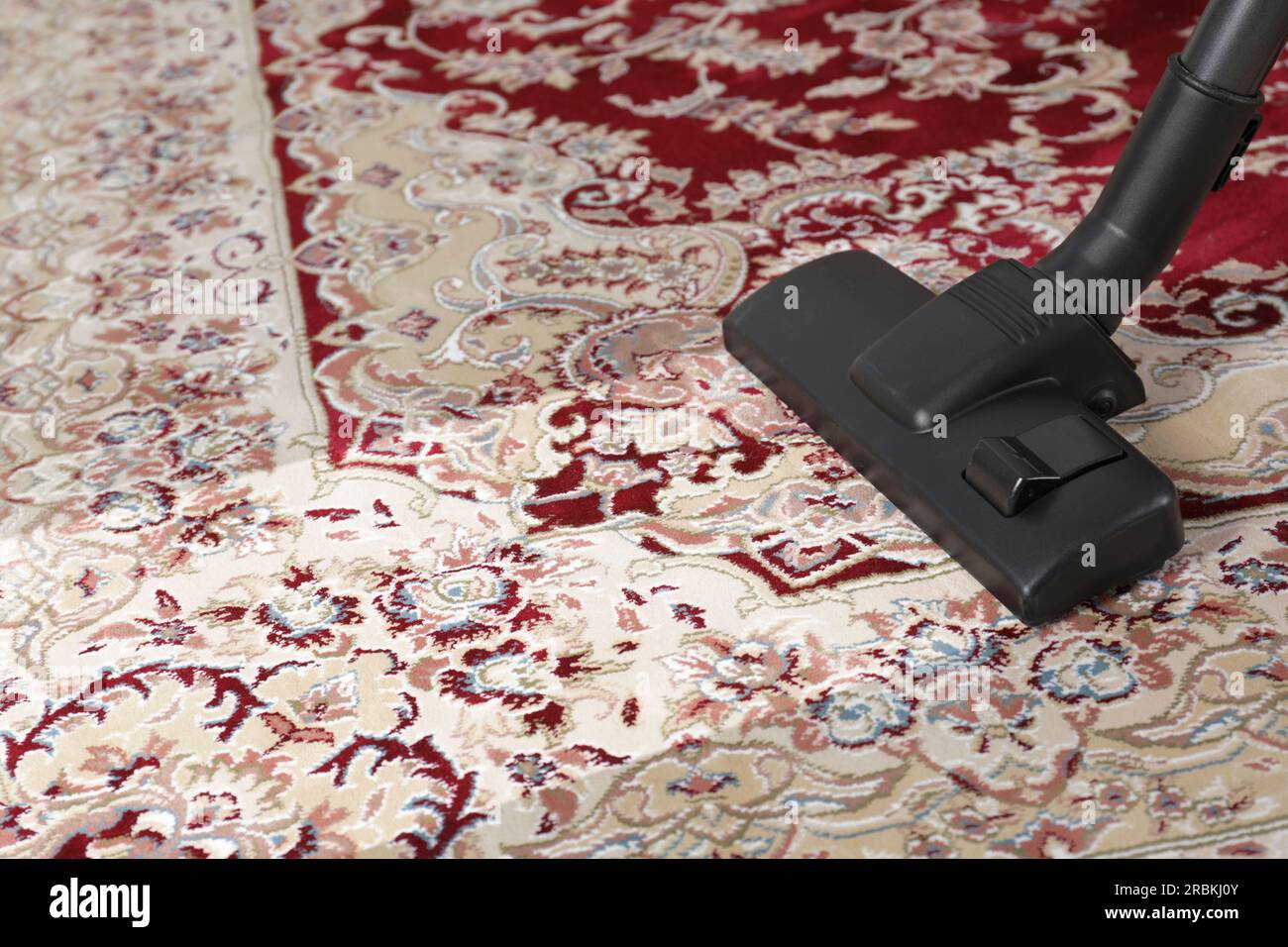 Hoovering carpet with vacuum cleaner, space for text. Clean trace on ...