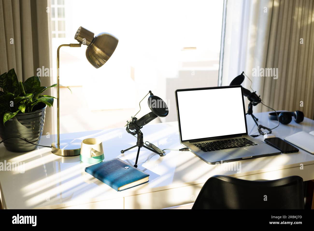 Headphones, laptop with copy space on screen and microphone on desk at ...