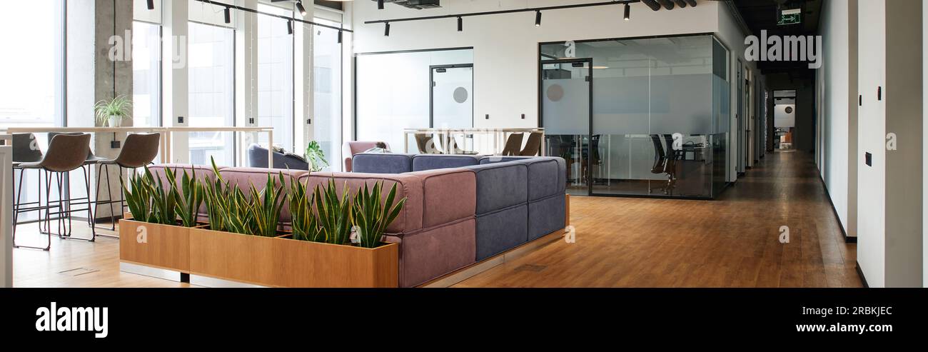 modern and spacious lounge with comfortable couch, high chairs near ...