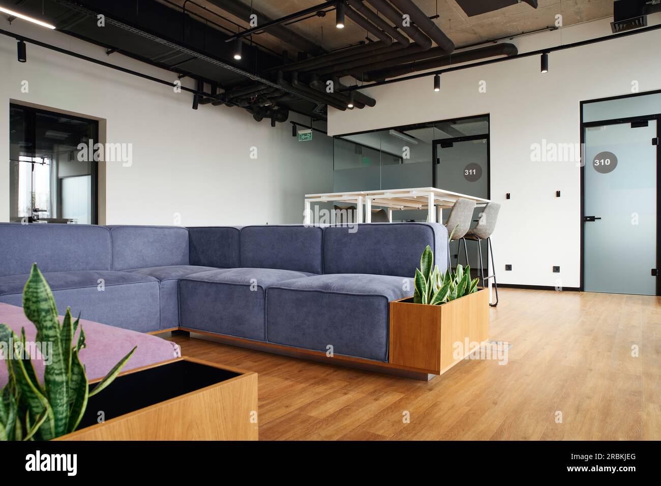 waiting zone, lounge in contemporary office with comfortable couch ...