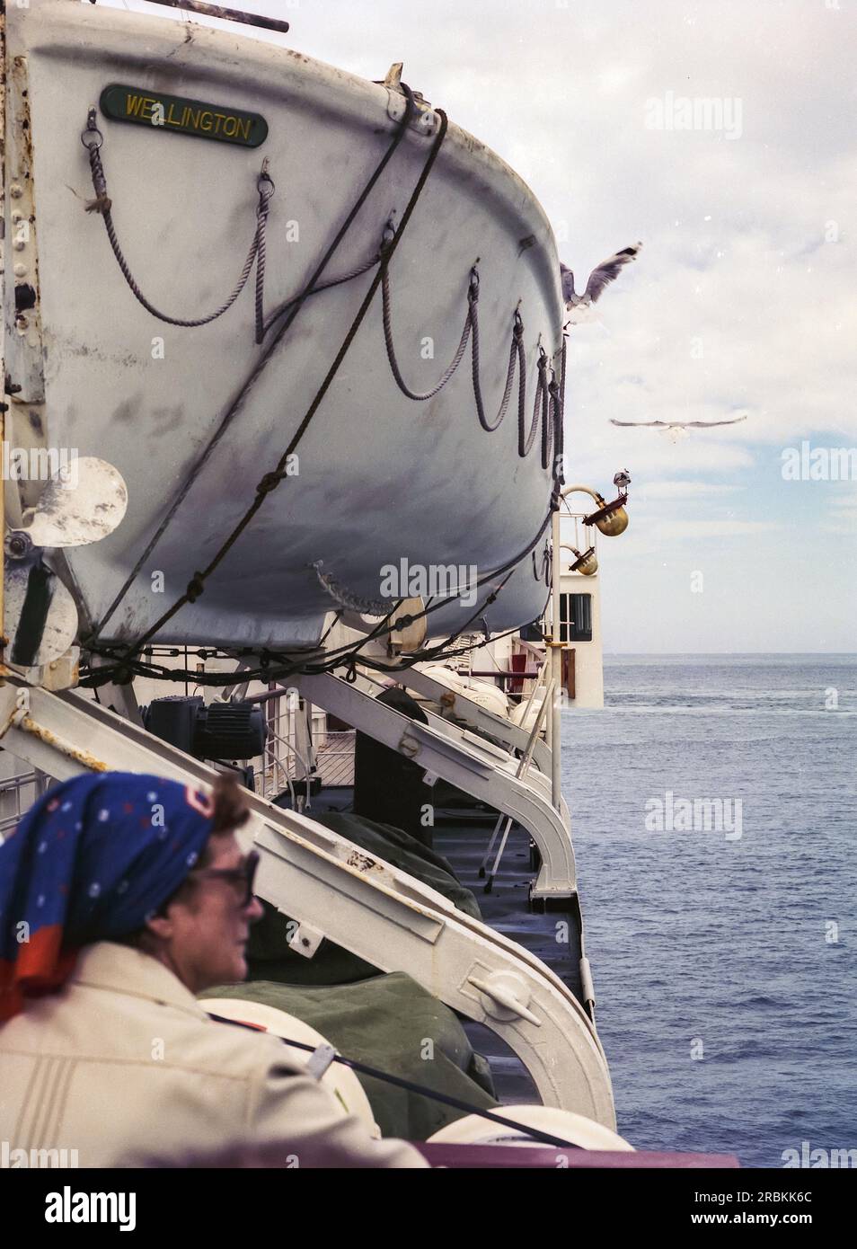 A 1981 historic image of people on the top deck of an interisland ferry ...