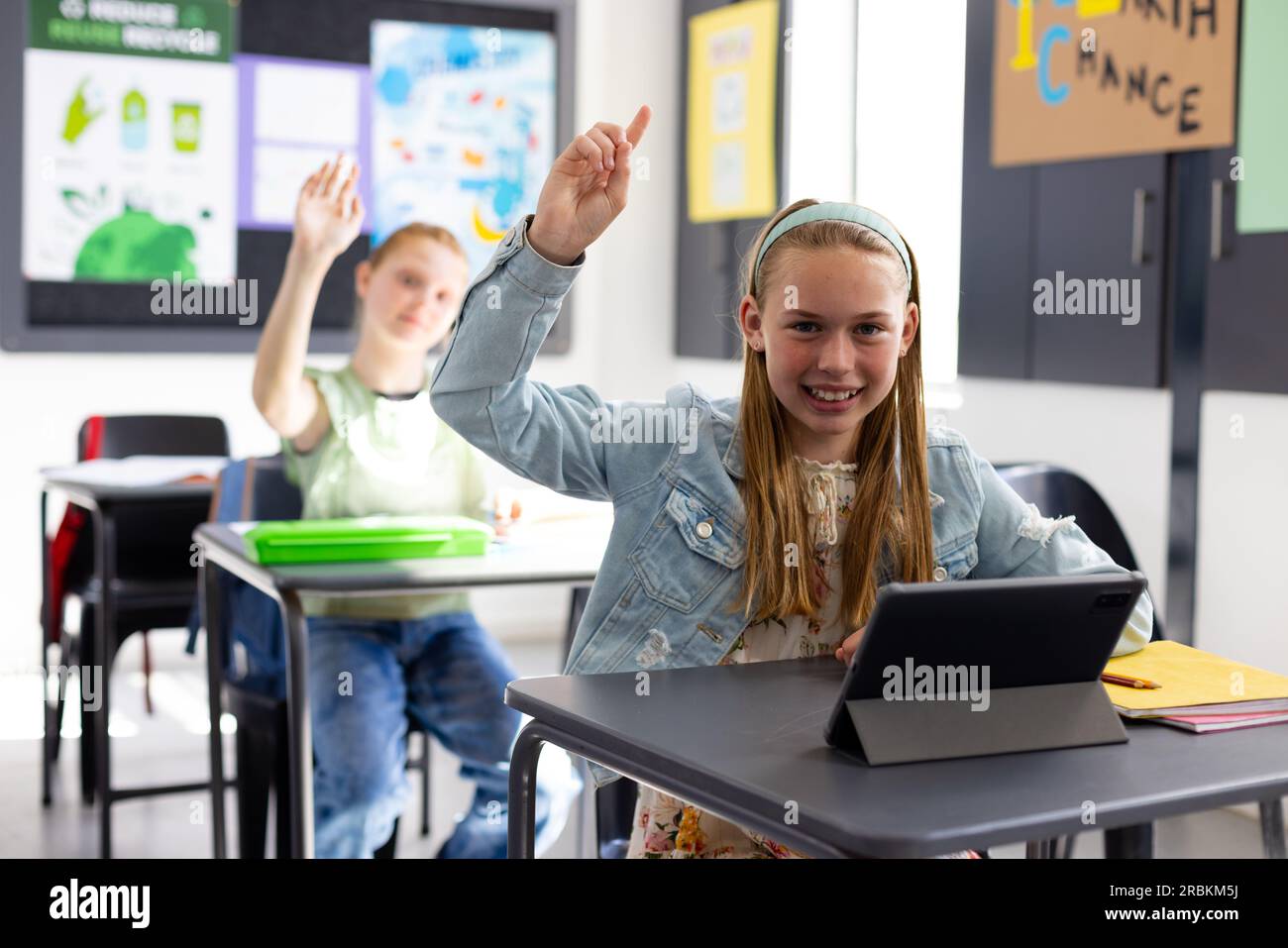 Happy diverse schoolchildren sitting at desks in school classroom Stock ...