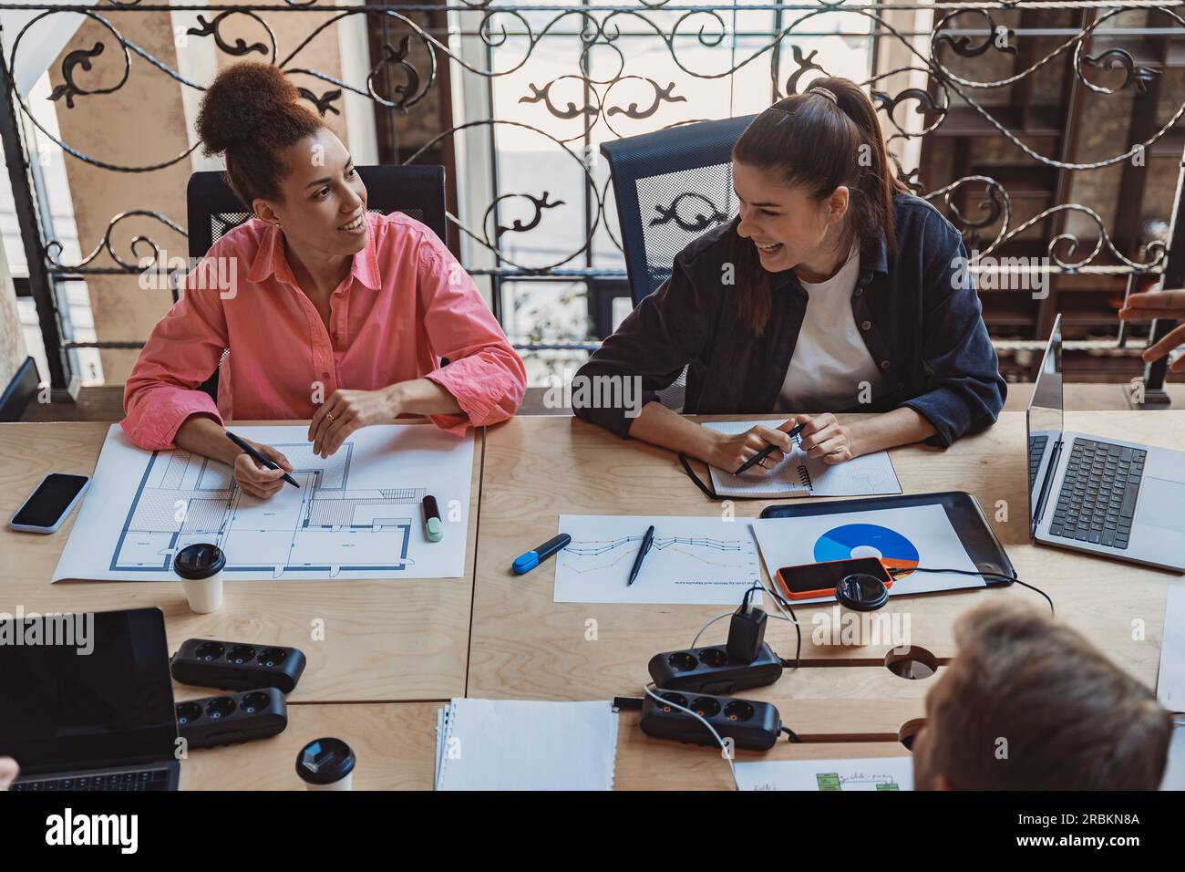 Group of coworkers working together and talking at modern office ...