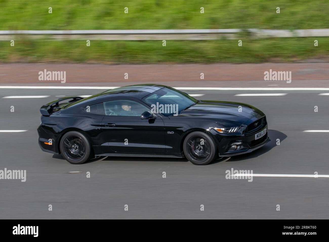 2016 Black Ford Mustang GT Auto; travelling at speed on the M6 motorway ...