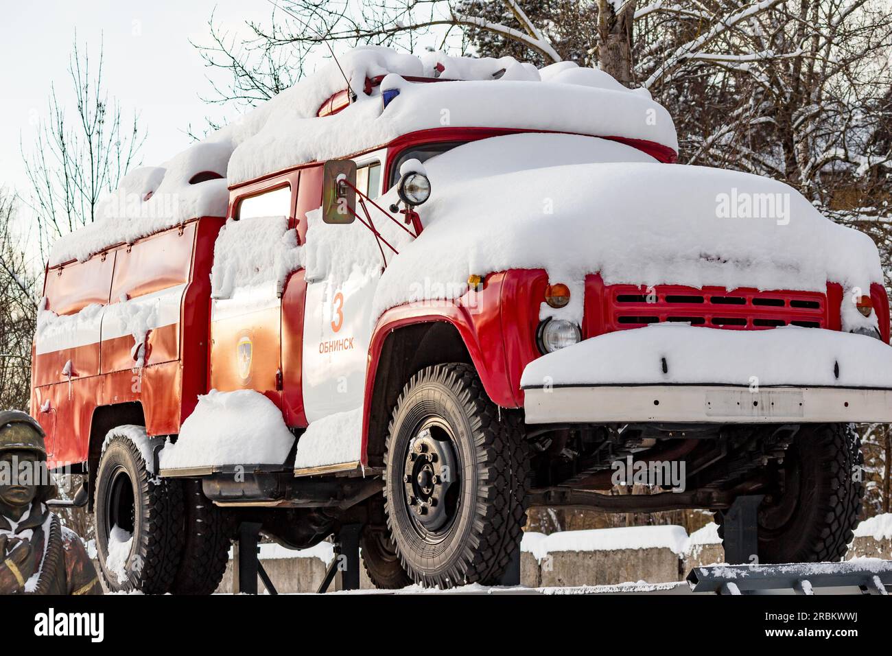 Fire truck ZiL-130 in the snow installed as a monument at the fire ...