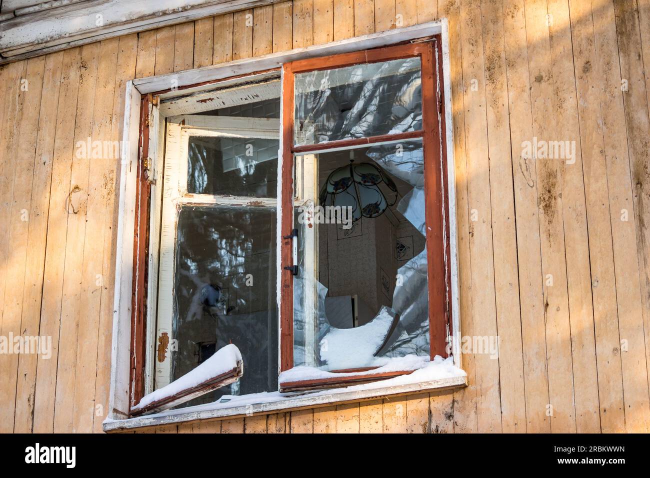 Broken window in an old abandoned house, view of the kitchen with a ...