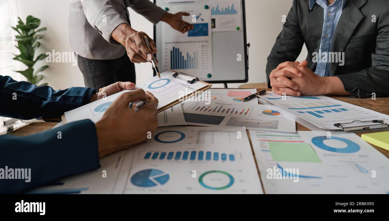 Business team analyzing income charts and graphs in office. Close up ...