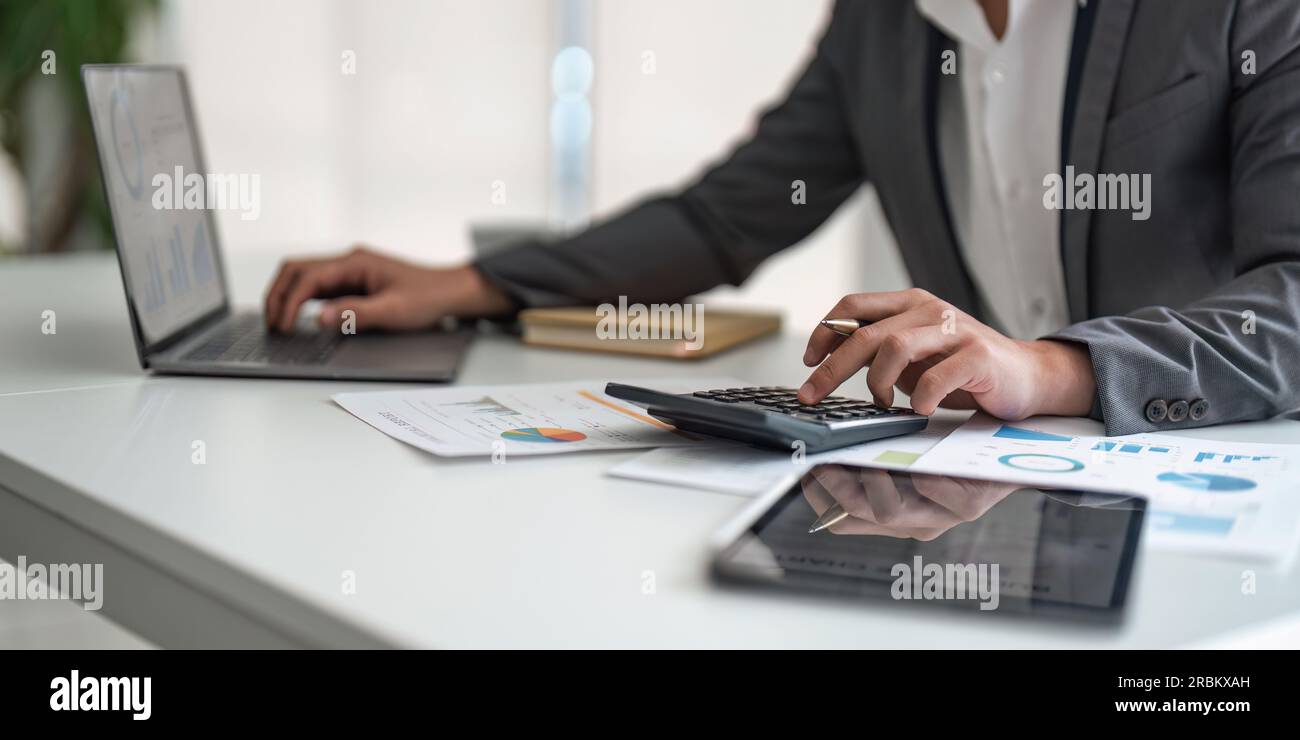 Young asian business man audit analysis graph company budget report ...