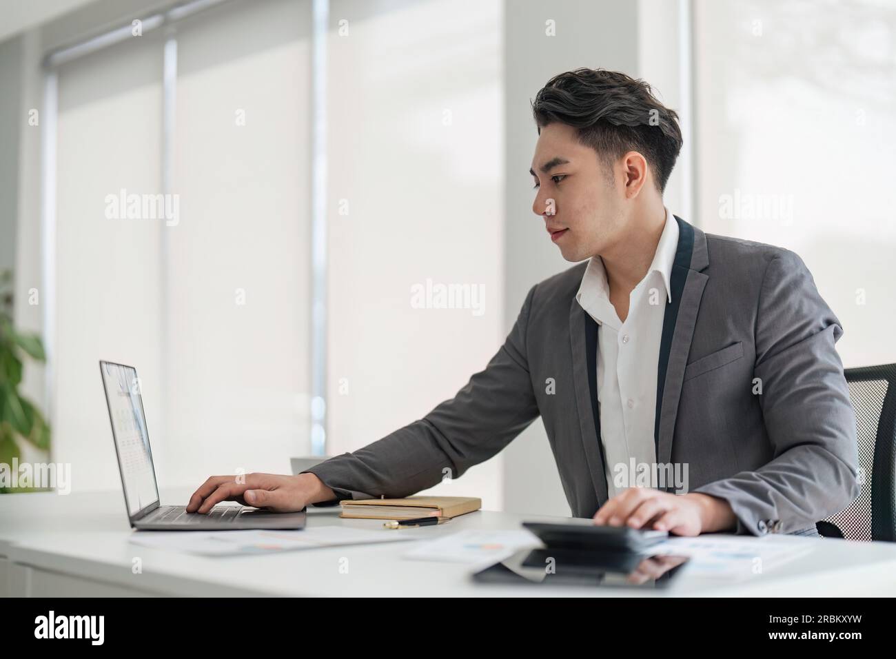 Young asian business man audit analysis graph company budget report ...