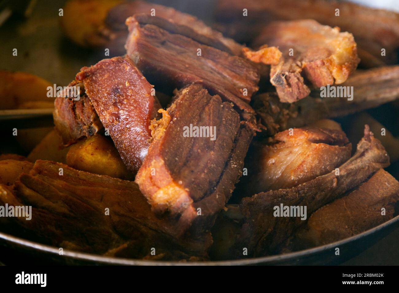 Pork chicharrón is a traditional food in Peru. Pork fat is used to cook ...