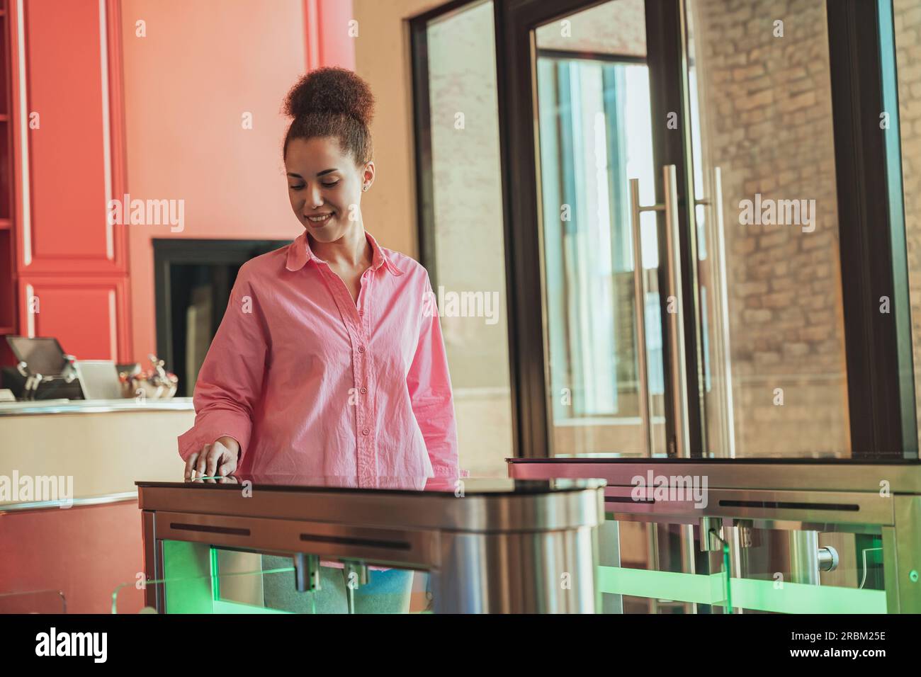 Business woman passing through to office entrance gate after ID card ...