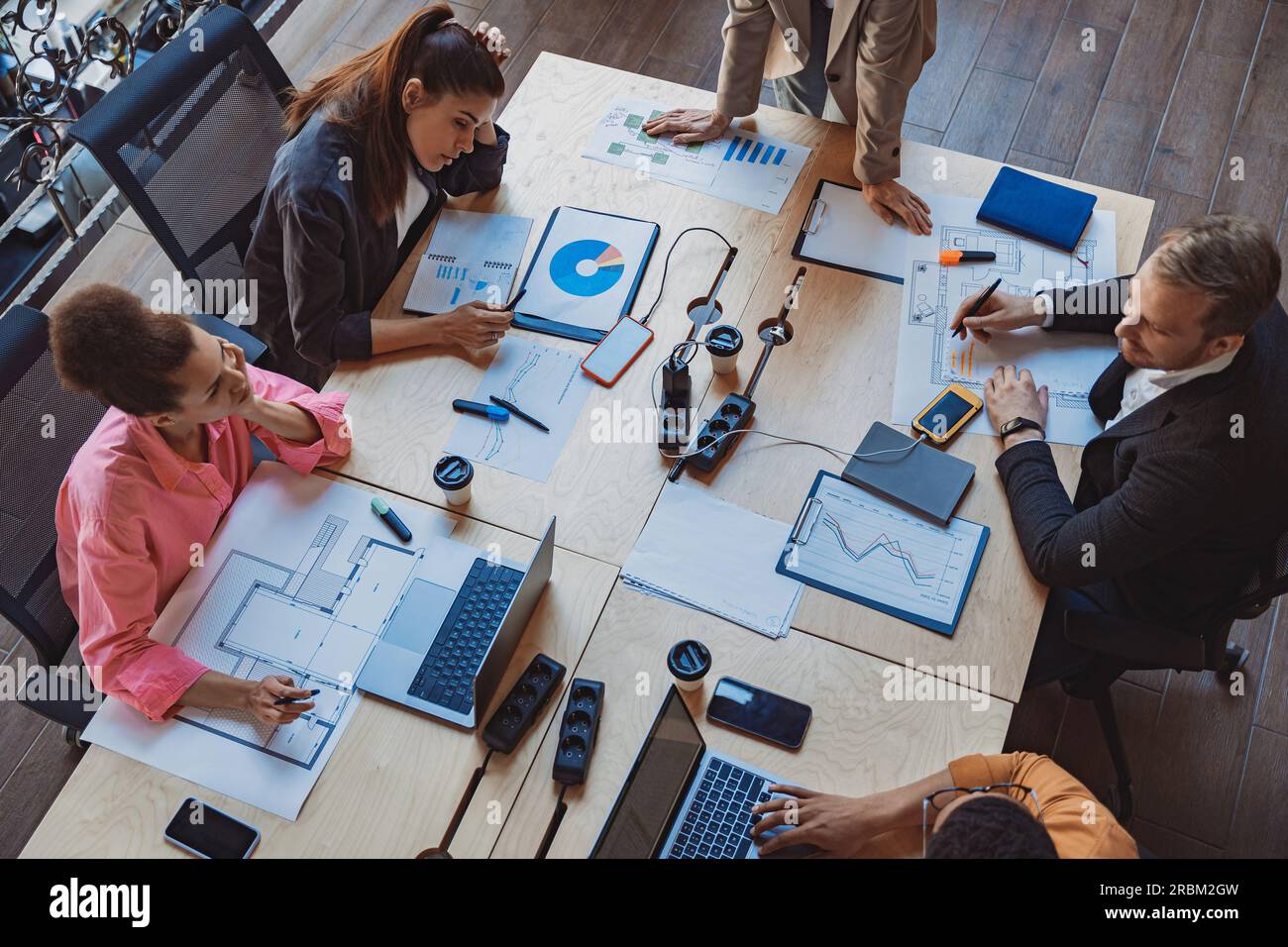 Diverse corporate team working together in meeting room. Colleagues ...