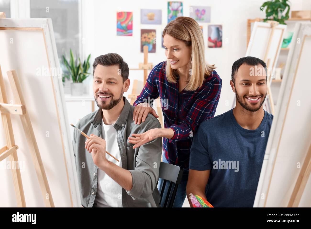Artist teaching her students to paint in studio. Creative hobby Stock ...