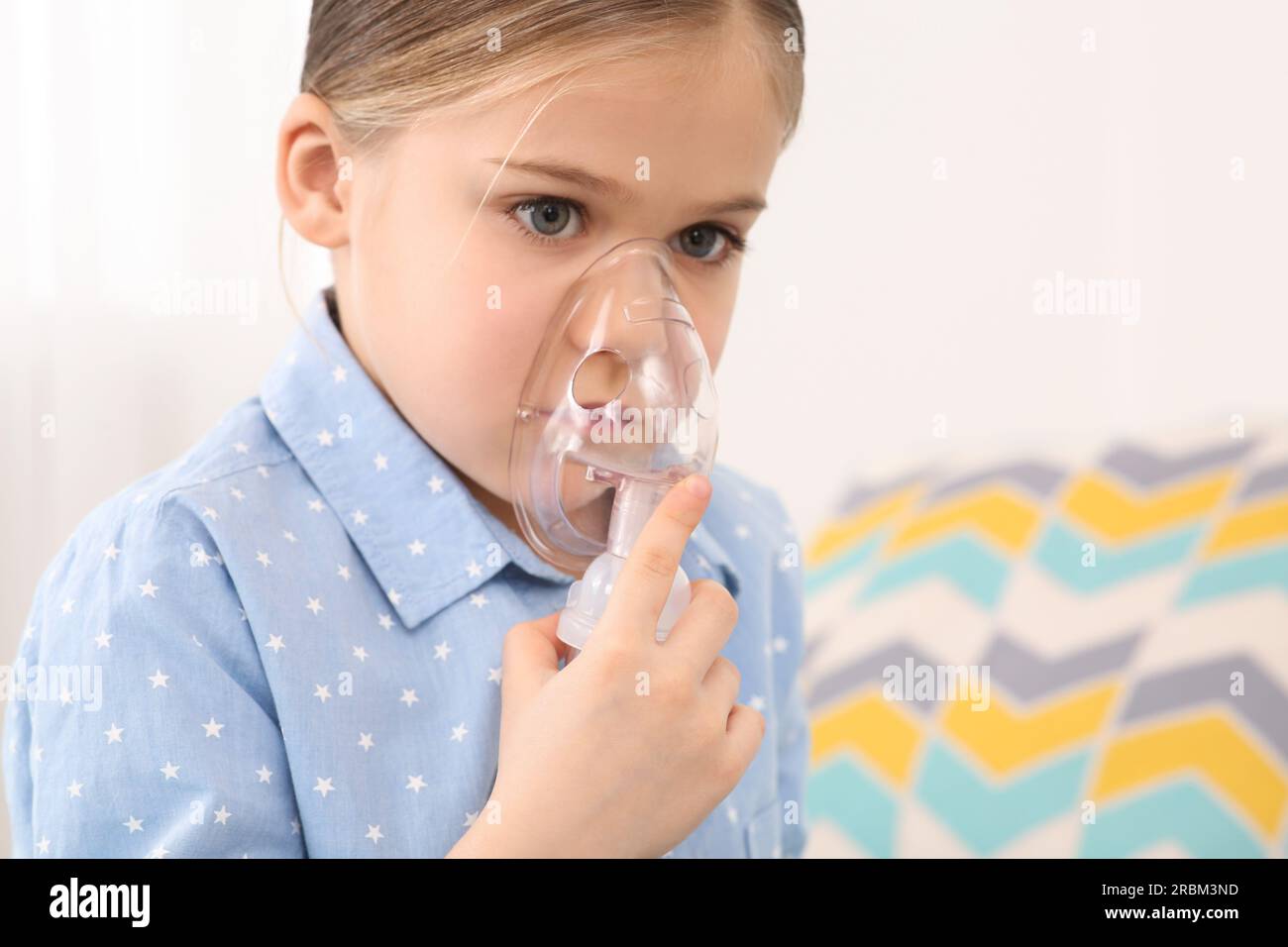 Sick little girl using nebulizer for inhalation indoors Stock Photo - Alamy