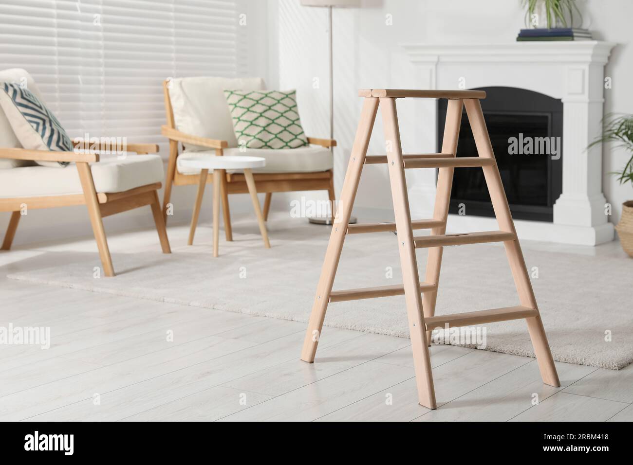 Wooden folding ladder in stylish living room Stock Photo - Alamy