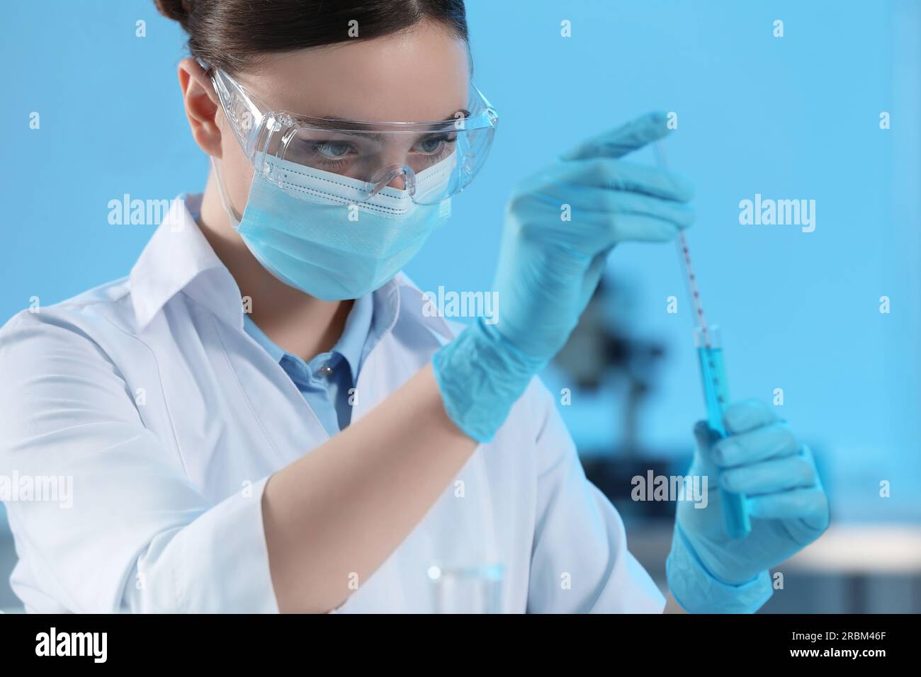 Scientist taking sample blue liquid hi-res stock photography and images ...