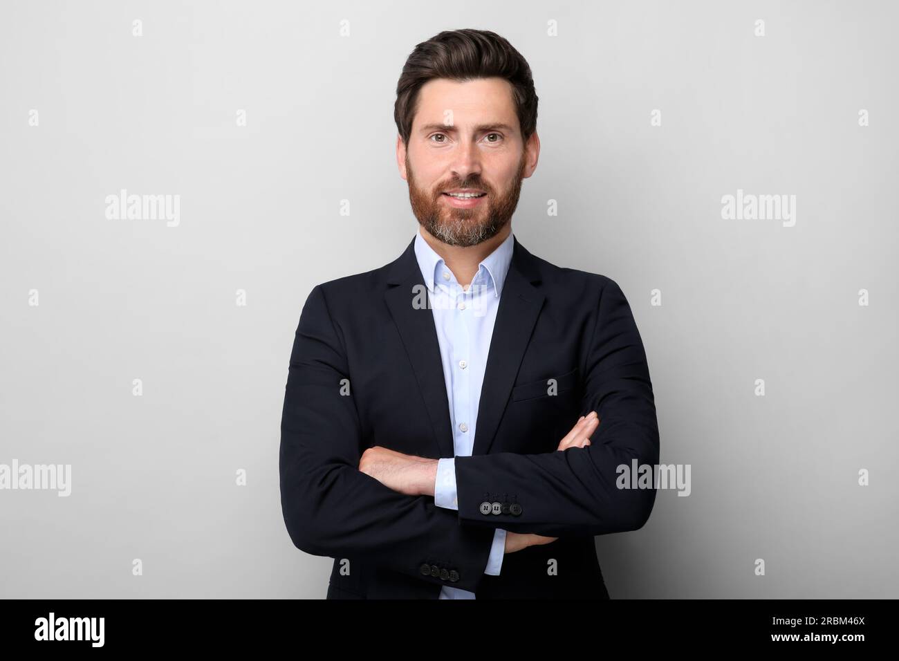Portrait of handsome man on light grey background Stock Photo - Alamy