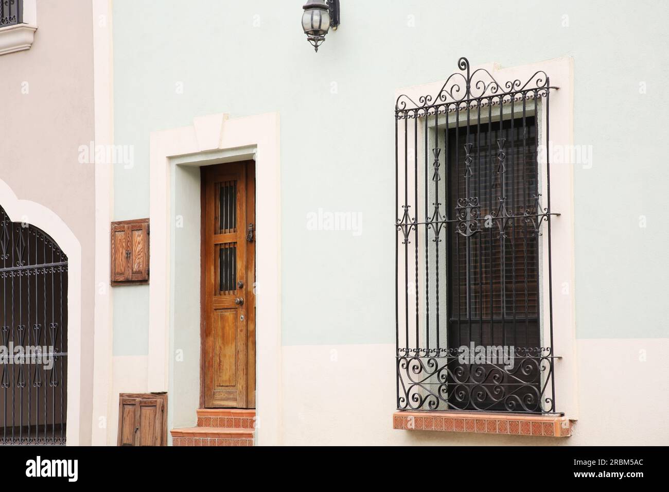 Light blue building with wooden door and window Stock Photo - Alamy