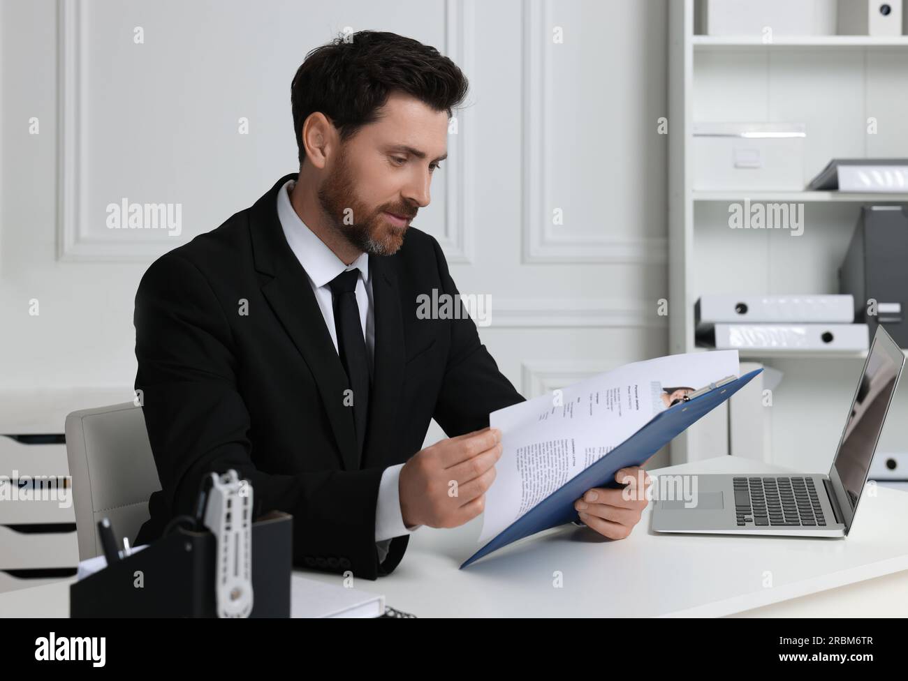 Human resources manager reading applicant's resume in office Stock ...