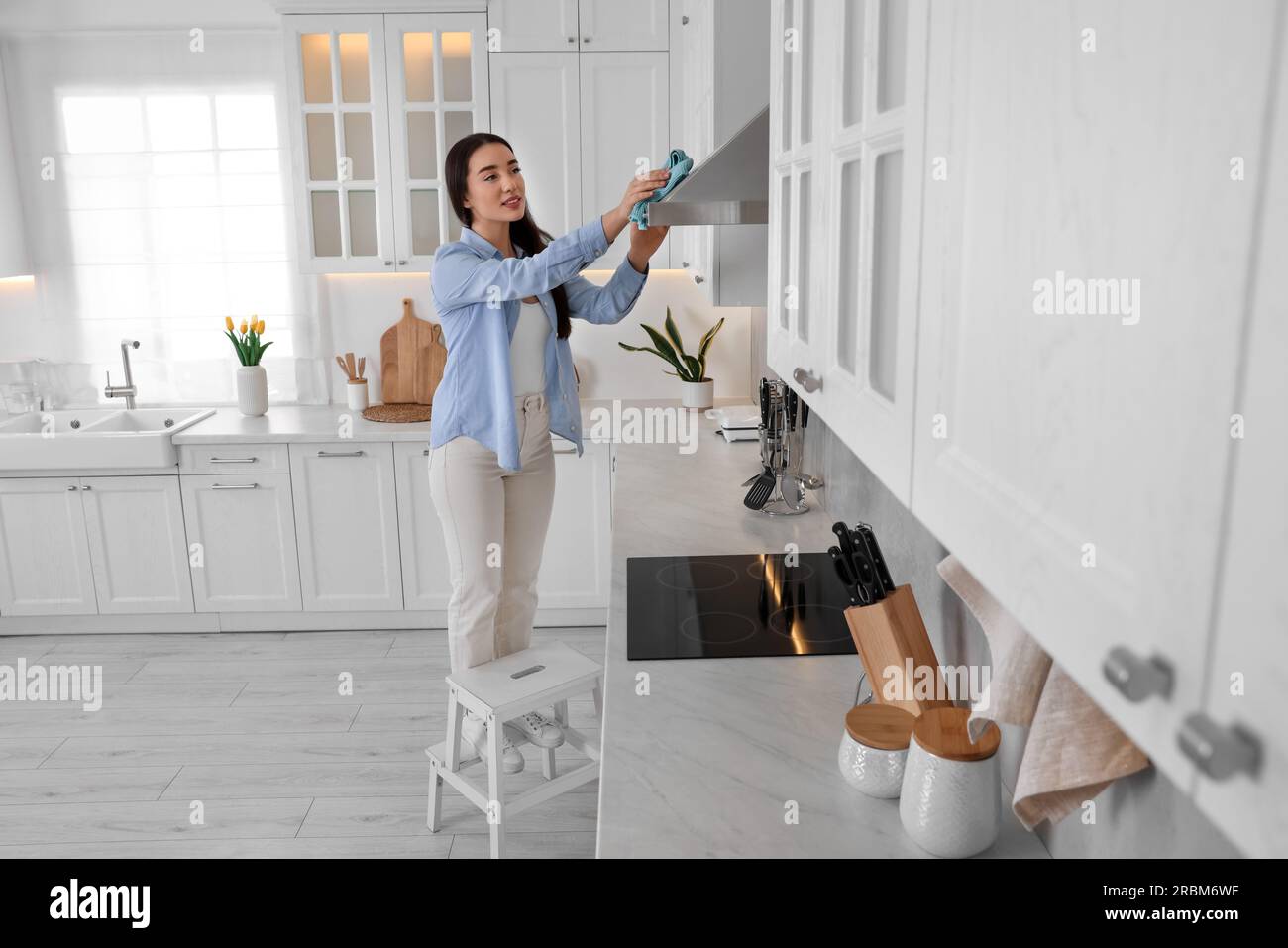 Woman on ladder cleaning hi-res stock photography and images - Alamy