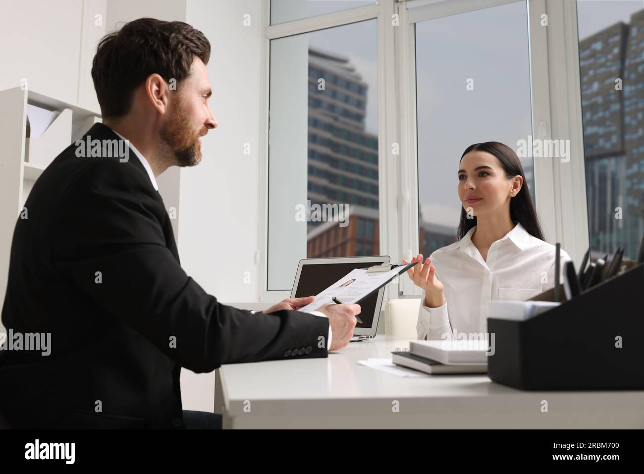 Human resources manager conducting job interview with applicant in office Stock Photo - Alamy