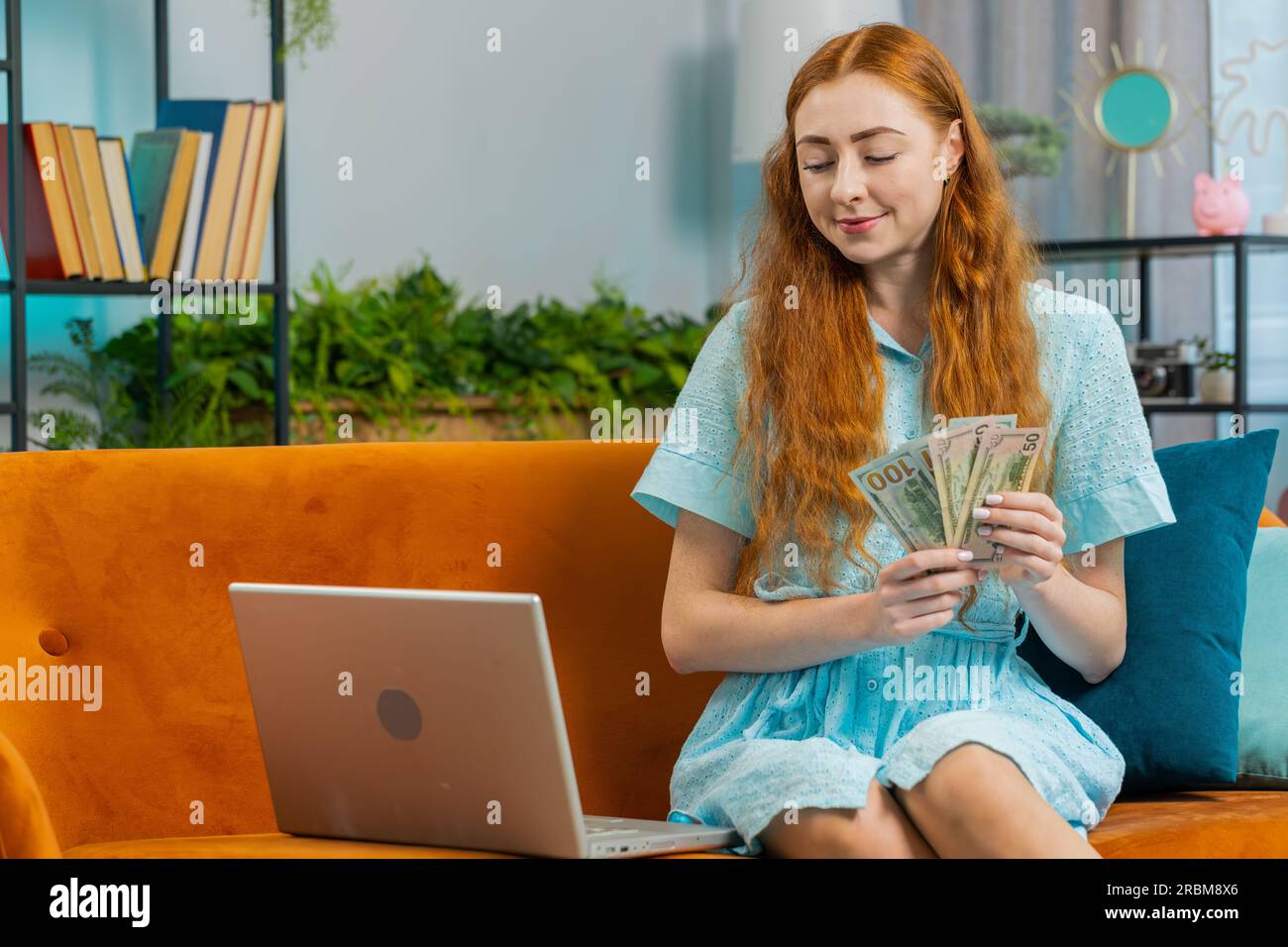 Planning budget. Rich happy redhead woman counting money cash use ...