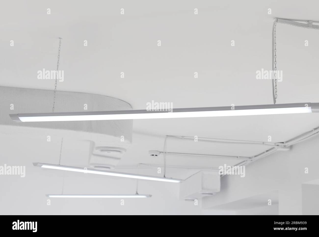 White ceiling with modern lighting in room Stock Photo - Alamy