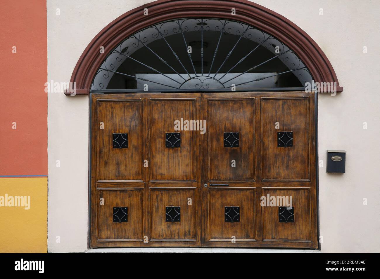 Exterior of building with beautiful wooden gates Stock Photo - Alamy