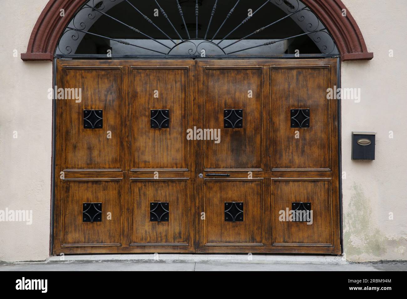 Exterior of building with beautiful wooden gates Stock Photo - Alamy