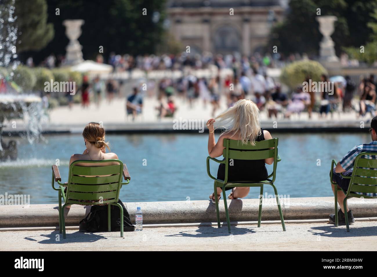 Jardin des Tuileries. People sit by fountain by Grand Bassin Rond on ...