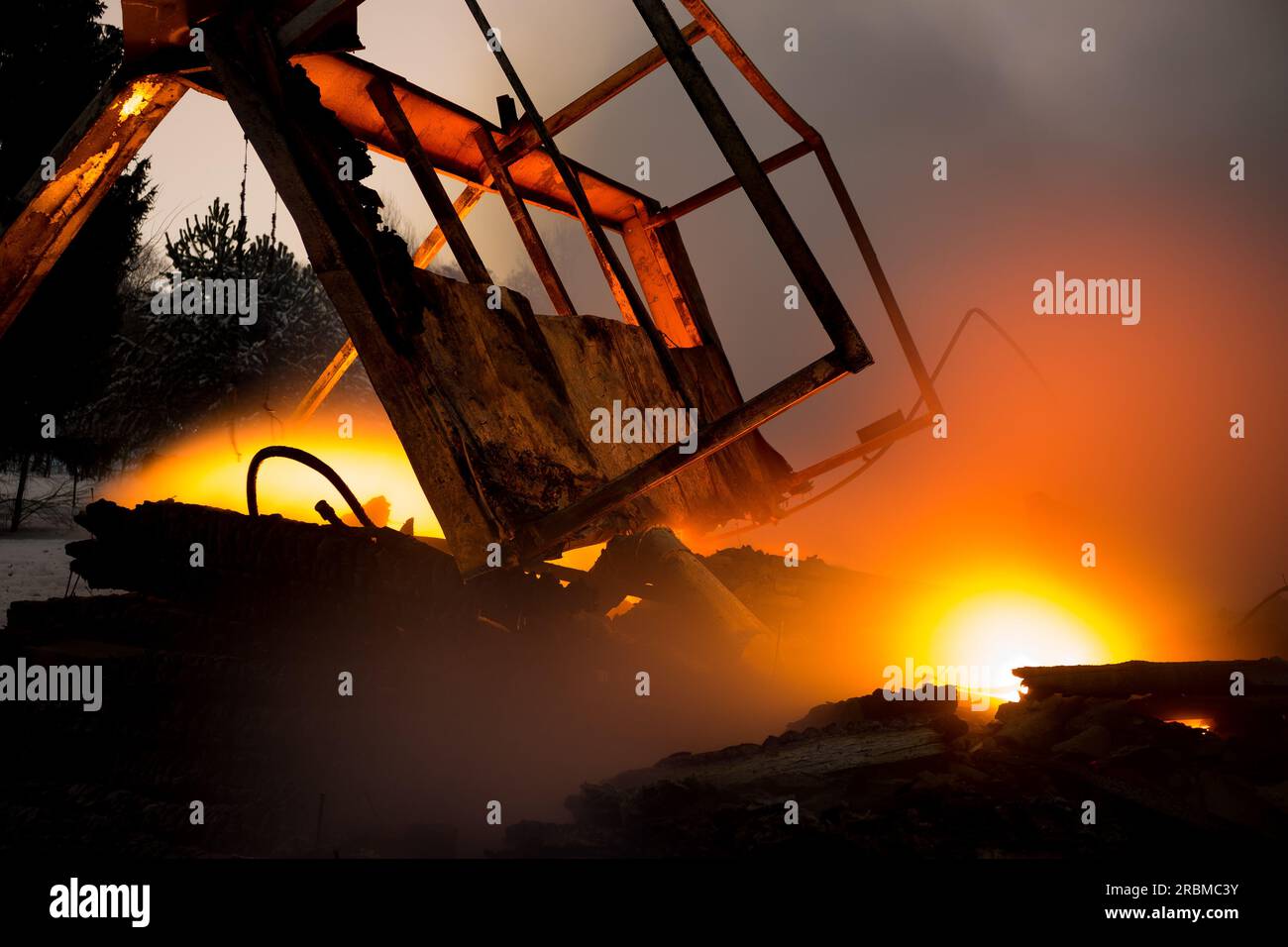 Burning out remains of a wooden house at night. Fire in the private ...