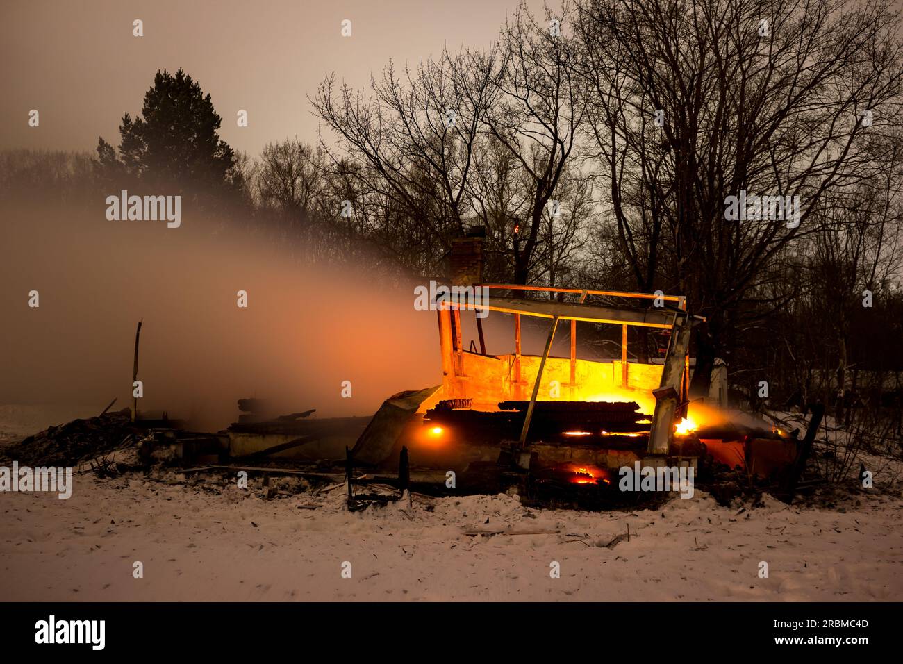 Fire in the private sector. Burning building, night view. Burning out ...