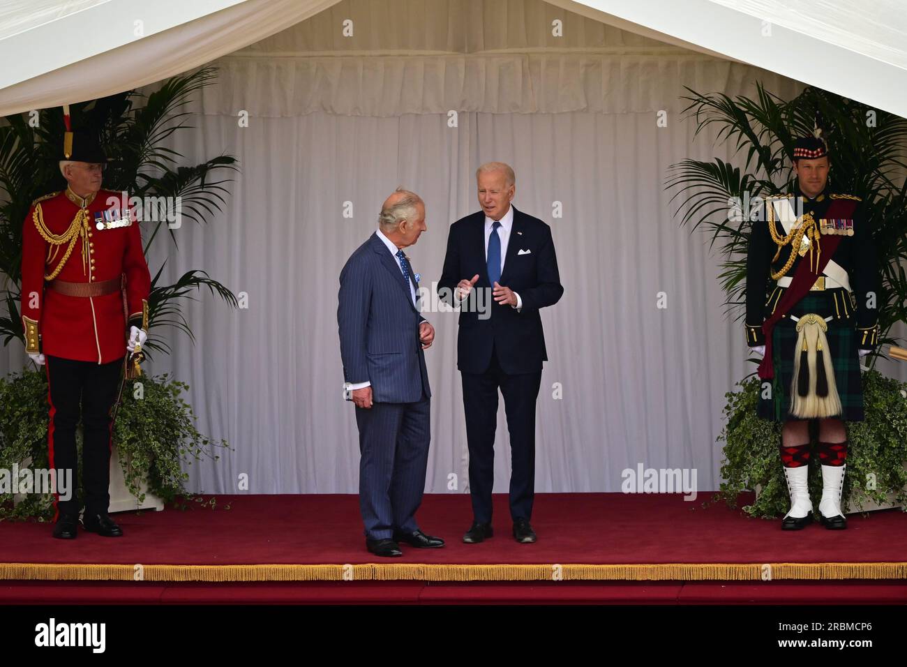 US President Joe Biden (right) speaks with King Charles III (left) on ...