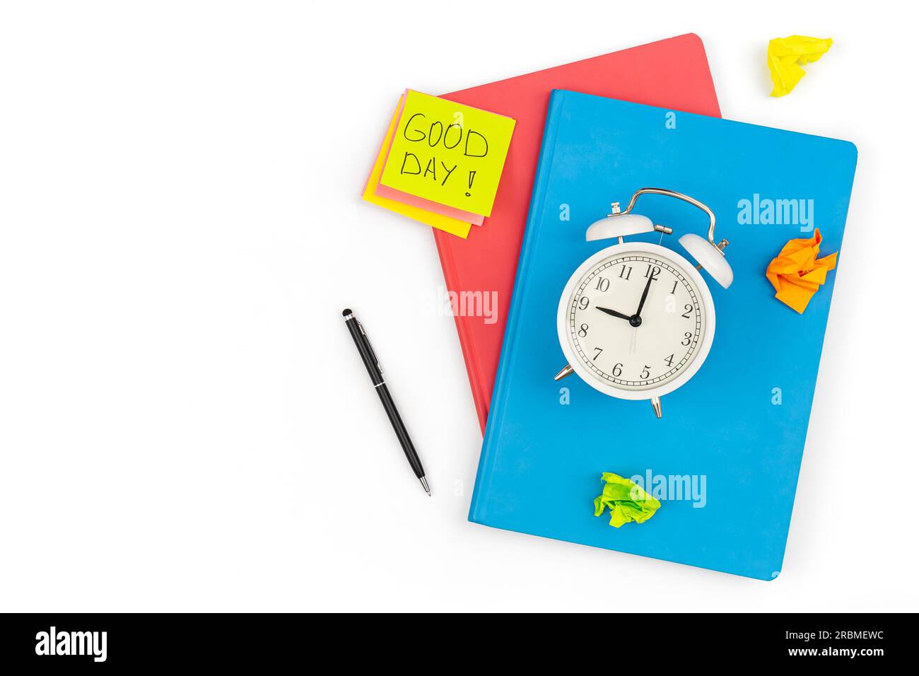 Notebooks, an alarm clock and a paper reminders on a white background ...