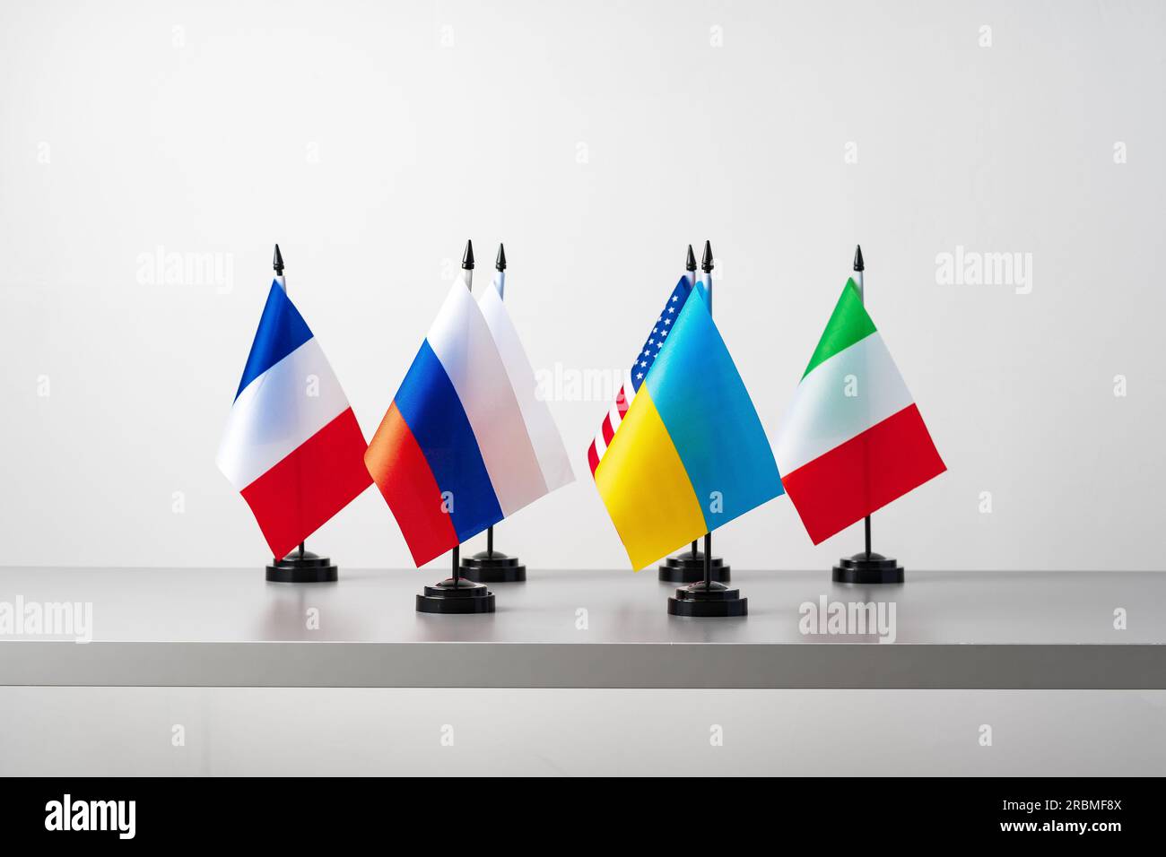 Small country flags standing at a table Stock Photo - Alamy