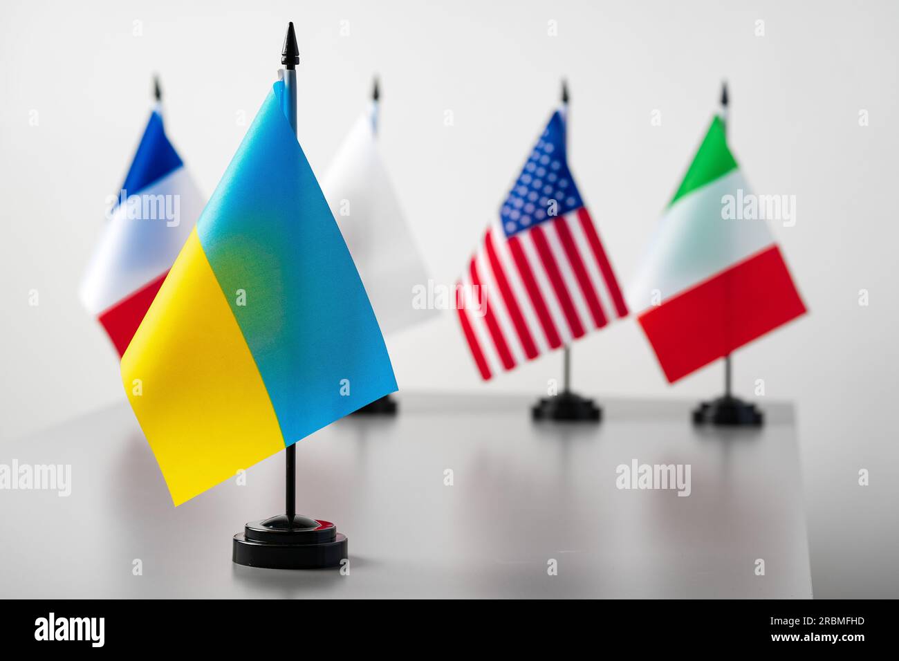 Small country flags standing at a table Stock Photo - Alamy