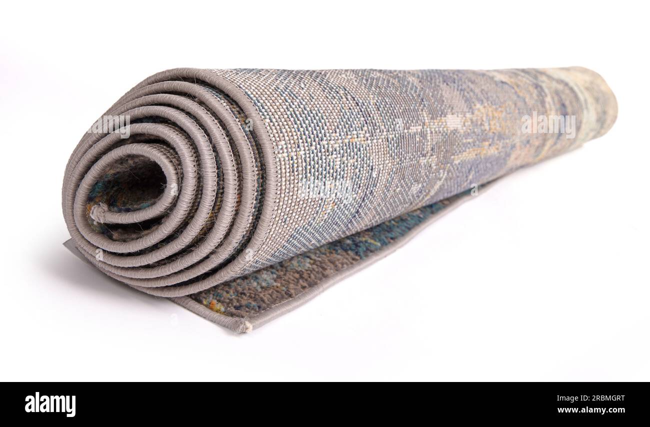 Rolled up carpet isolated on a white background Stock Photo - Alamy