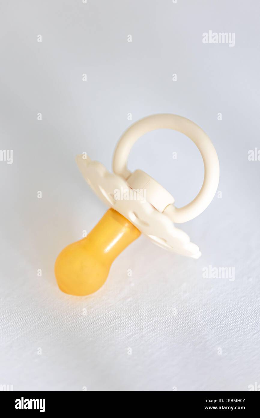 Baby's pacifier on a blurred white background Stock Photo - Alamy