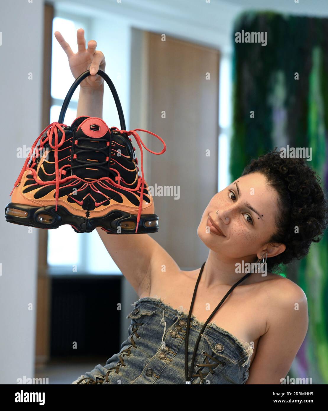 10 July 2023, Berlin: Designer All Amin shows a handbag from her label ...
