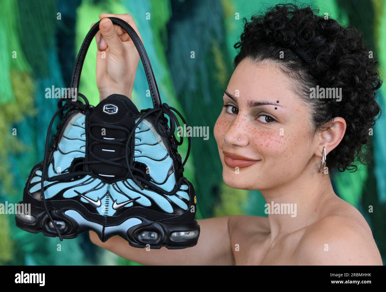 10 July 2023, Berlin: Designer All Amin shows a handbag from her label ...
