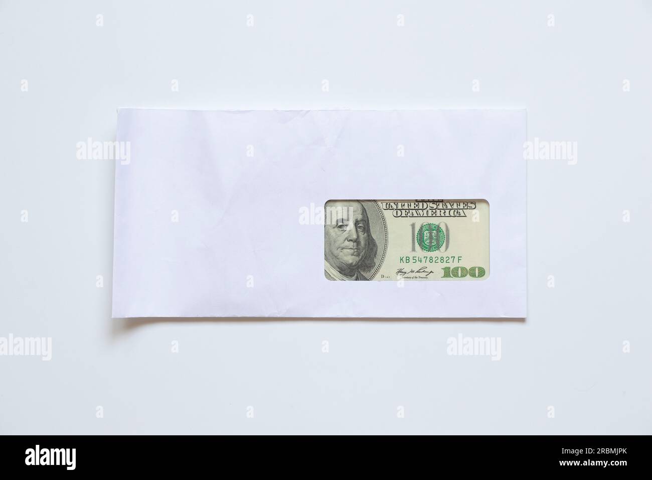 White envelope and one hundred dollars lie in an envelope on an ...