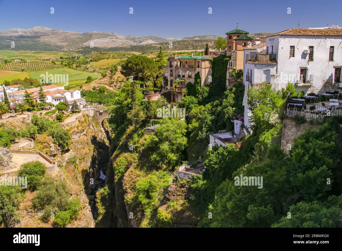 View of the Ronda gorge from the well-known Puente Nuevo bridge with ...