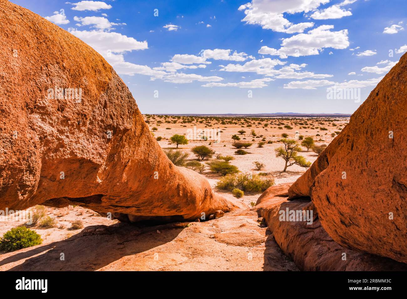A natural granite rock arch at Spitzkoppe in front of the surrounding ...