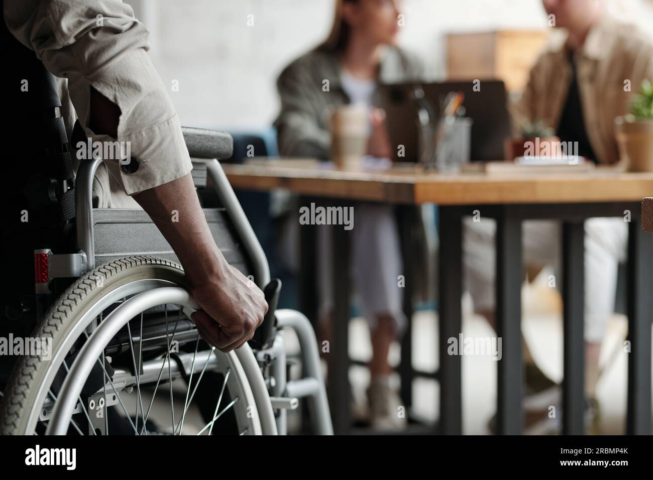 Part of young African American male employee with disability keeping ...