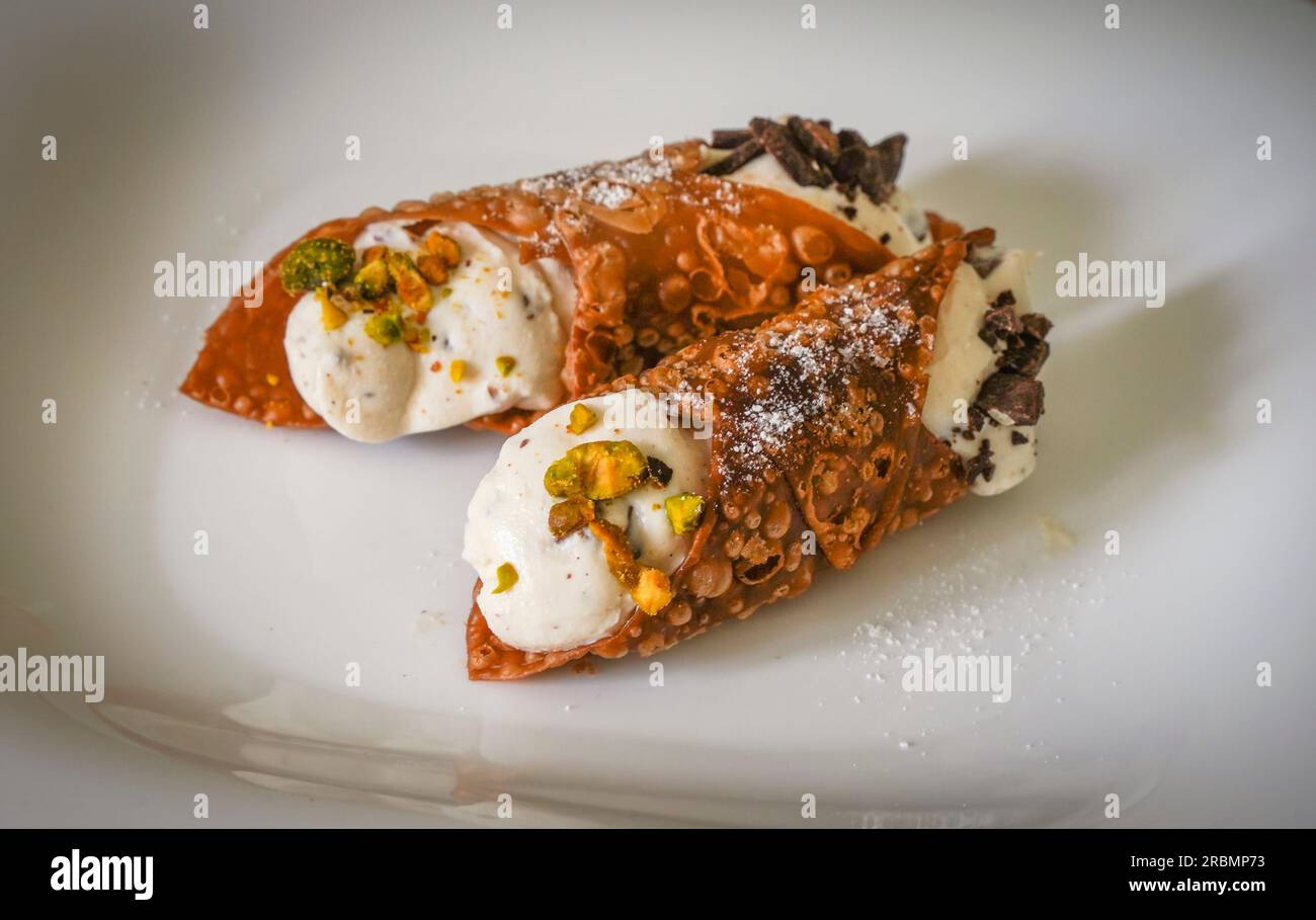 Home made Italian cannoli filled with ricotta cream on white plate ...