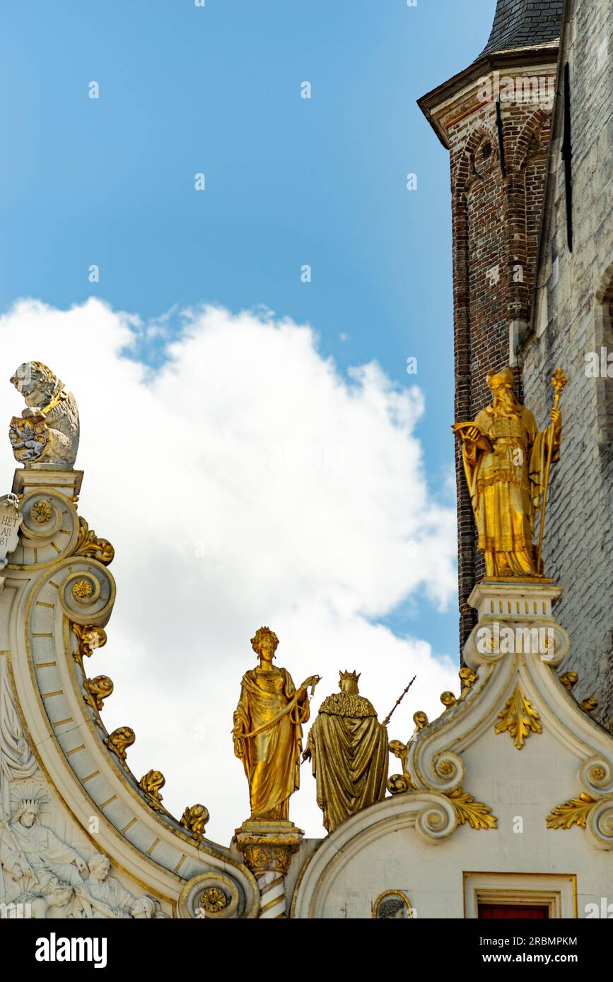 Statues posted on the buildings surrounding the Burg square in Bruges ...